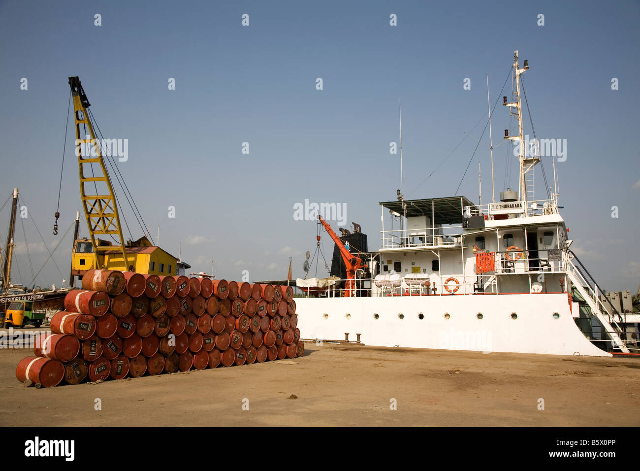 The port of Beypore in Kerala, India. Oil drums stand by the docked ...