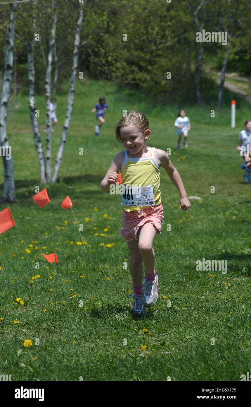 Young girl running in a cross country race Stock Photo - Alamy