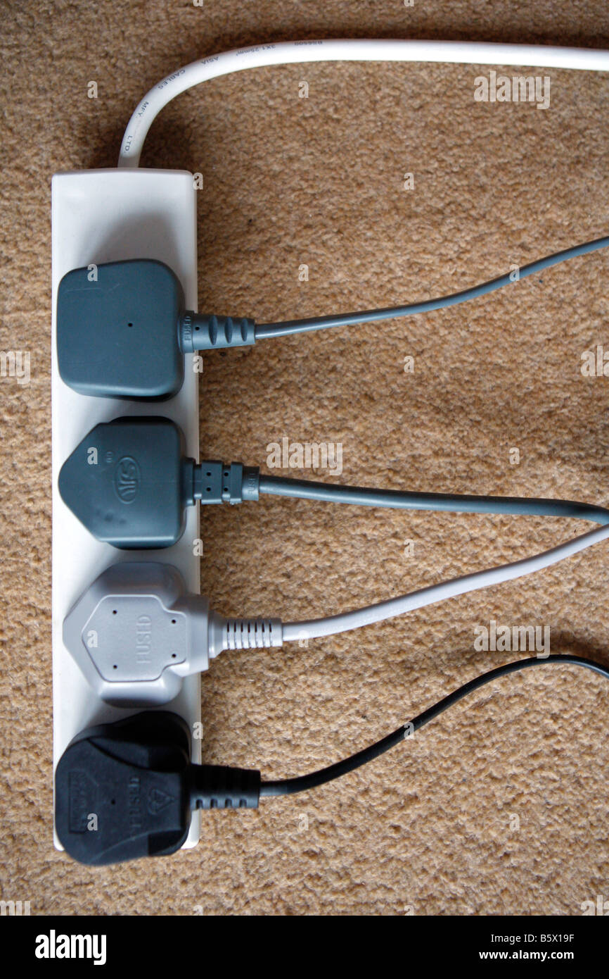 Electric power plugs in a four way adapter Stock Photo - Alamy