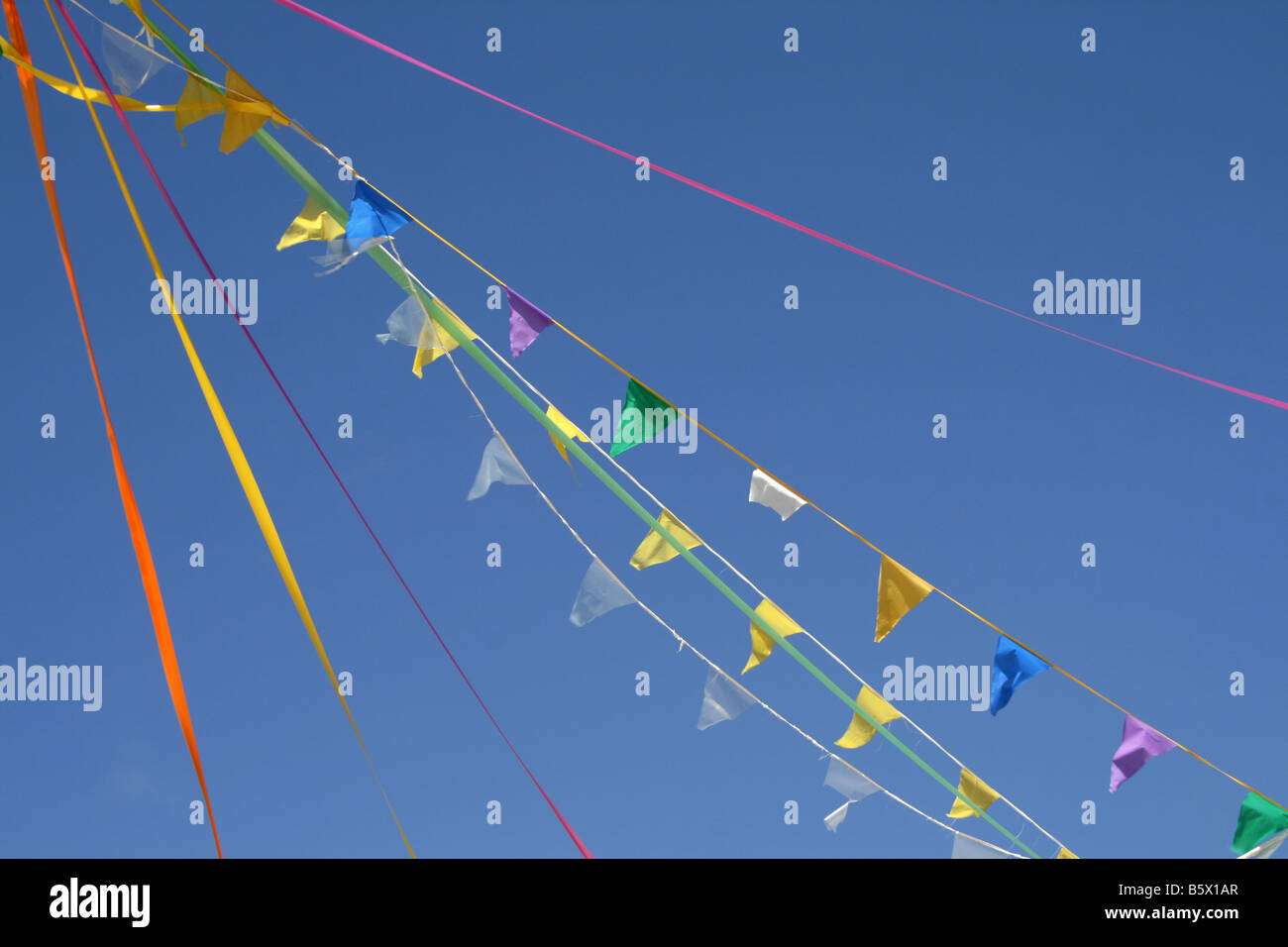 many colourful carnival flags decorations in street party outdoors in ...