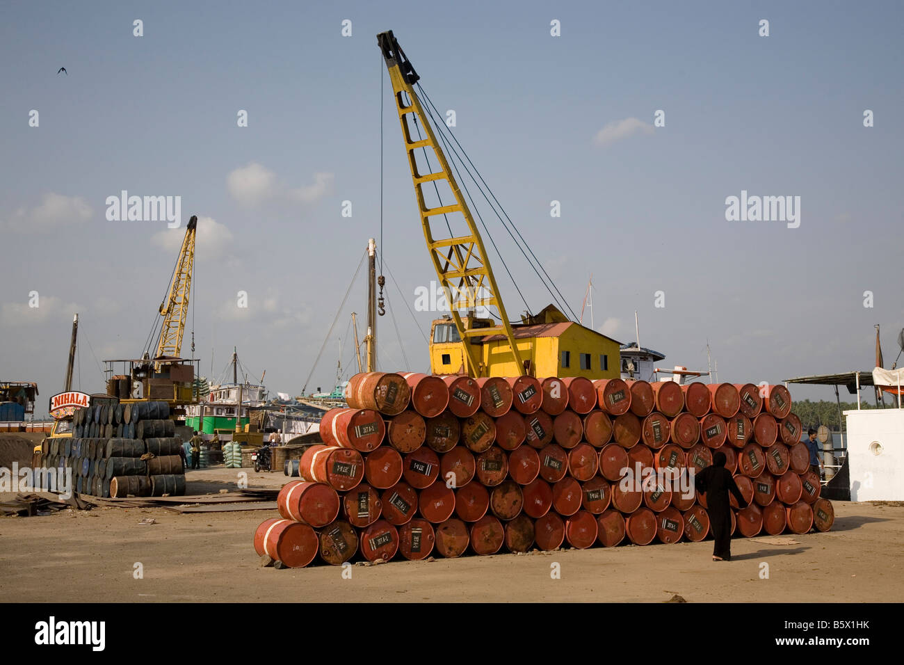 The port of Beypore in Kerala, India. Cranes and teams of workers help ...