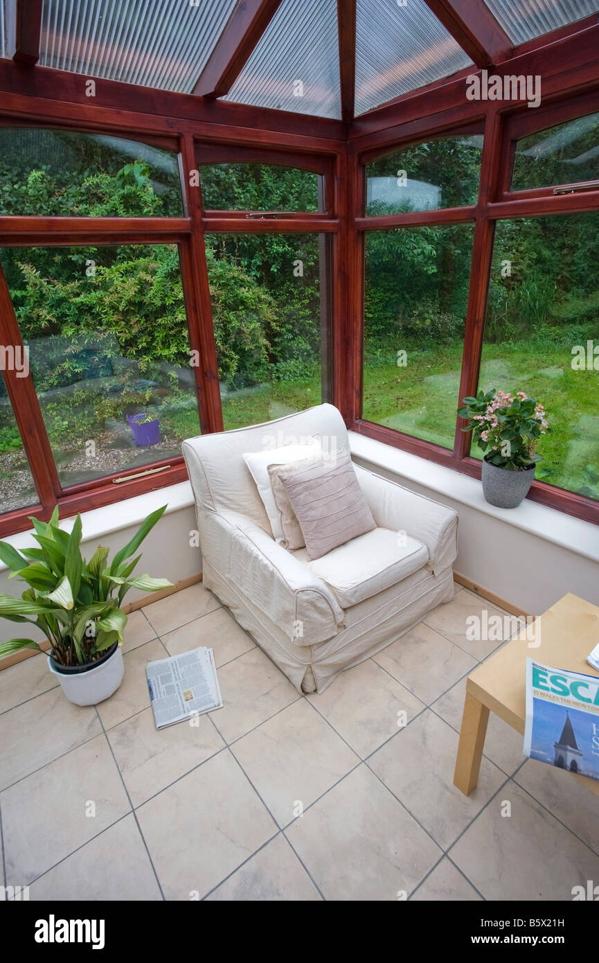 conservatory tables chairs plants room in house next to garden Stock ...