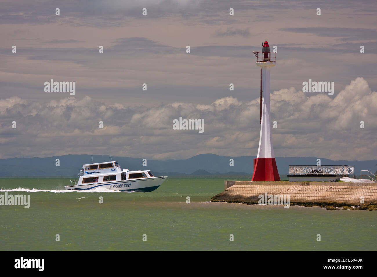 BELIZE CITY BELIZE Tour boat passes Fort George lighthouse on way into ...