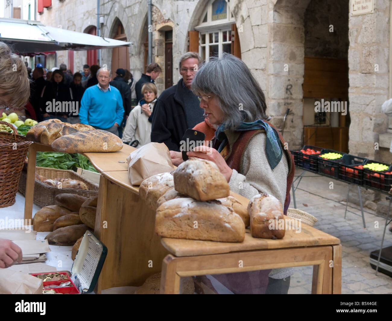 stall on market place woman buying white bread at the bakers stall ...