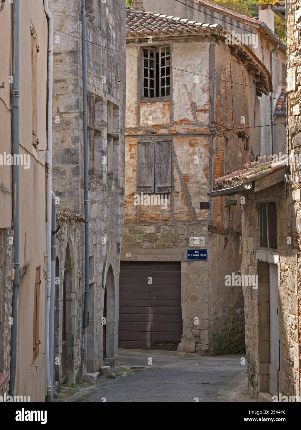 lane in old town old house with broken window and crumbled house front ...