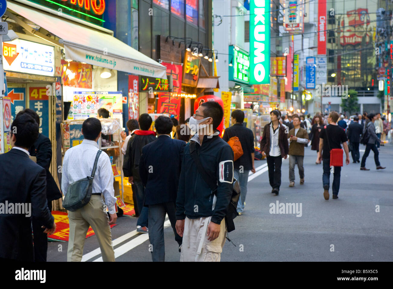 Man wearing mask amongst shoppers in Akihabara, Tokyo, Japan Stock ...