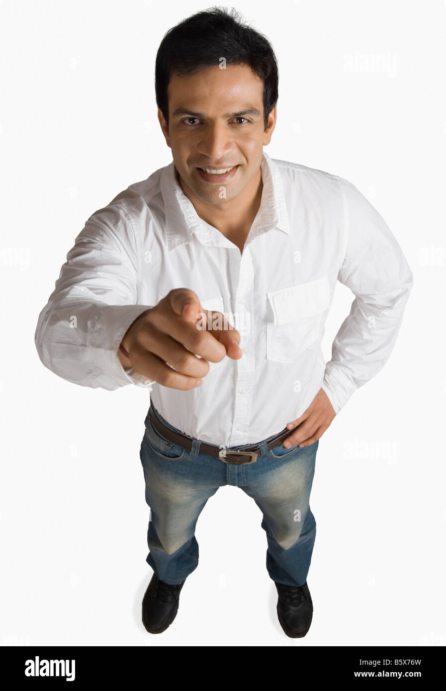 Portrait of a young man pointing and smiling Stock Photo - Alamy