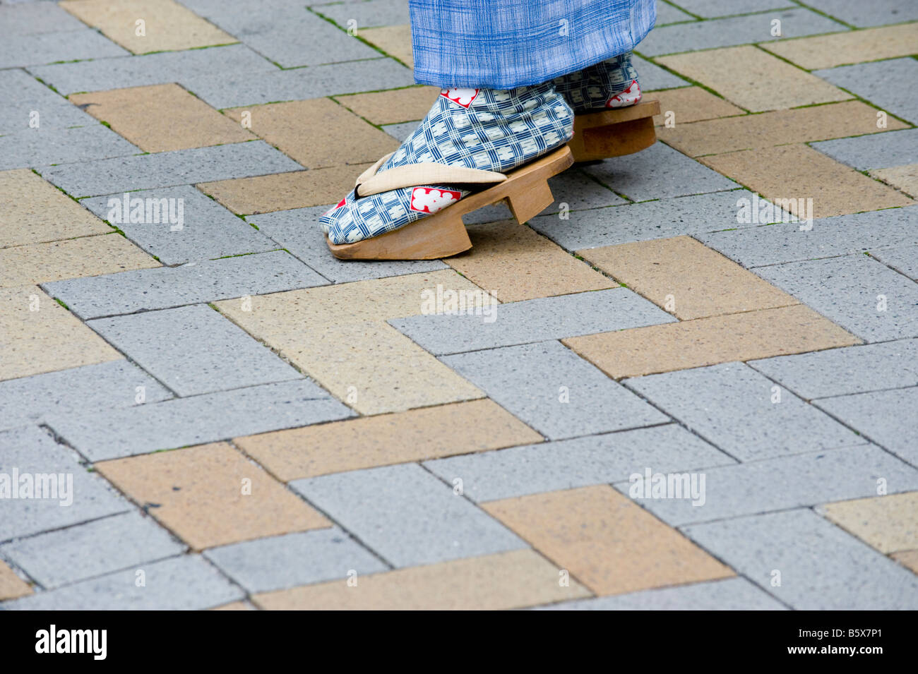 Man wearing geta Japanese wooden shoes under a kimono in Asakusa, Tokyo ...