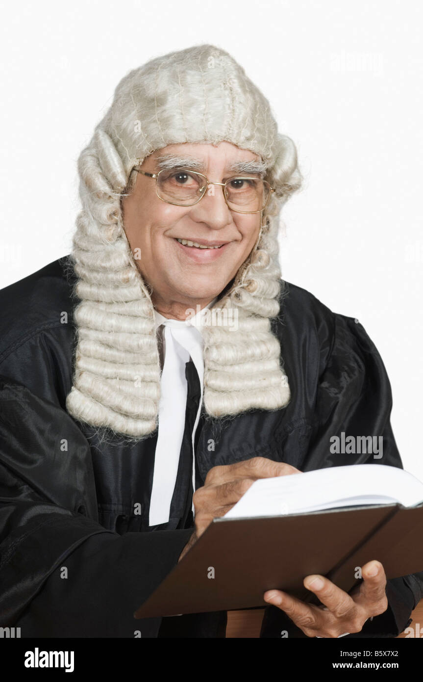 Portrait of a magistrate holding a book and smiling Stock Photo - Alamy