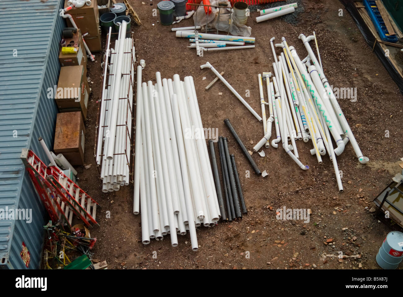 Piles of tubing at a construction site Stock Photo - Alamy