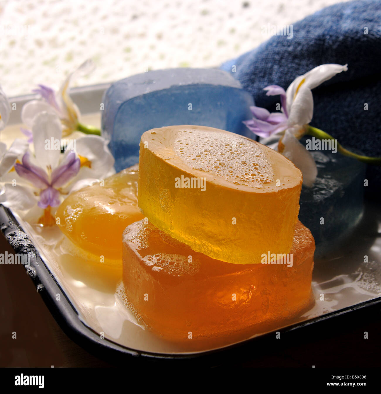 blue and yellow glycerin soaps with fortnightly lilies Stock Photo - Alamy