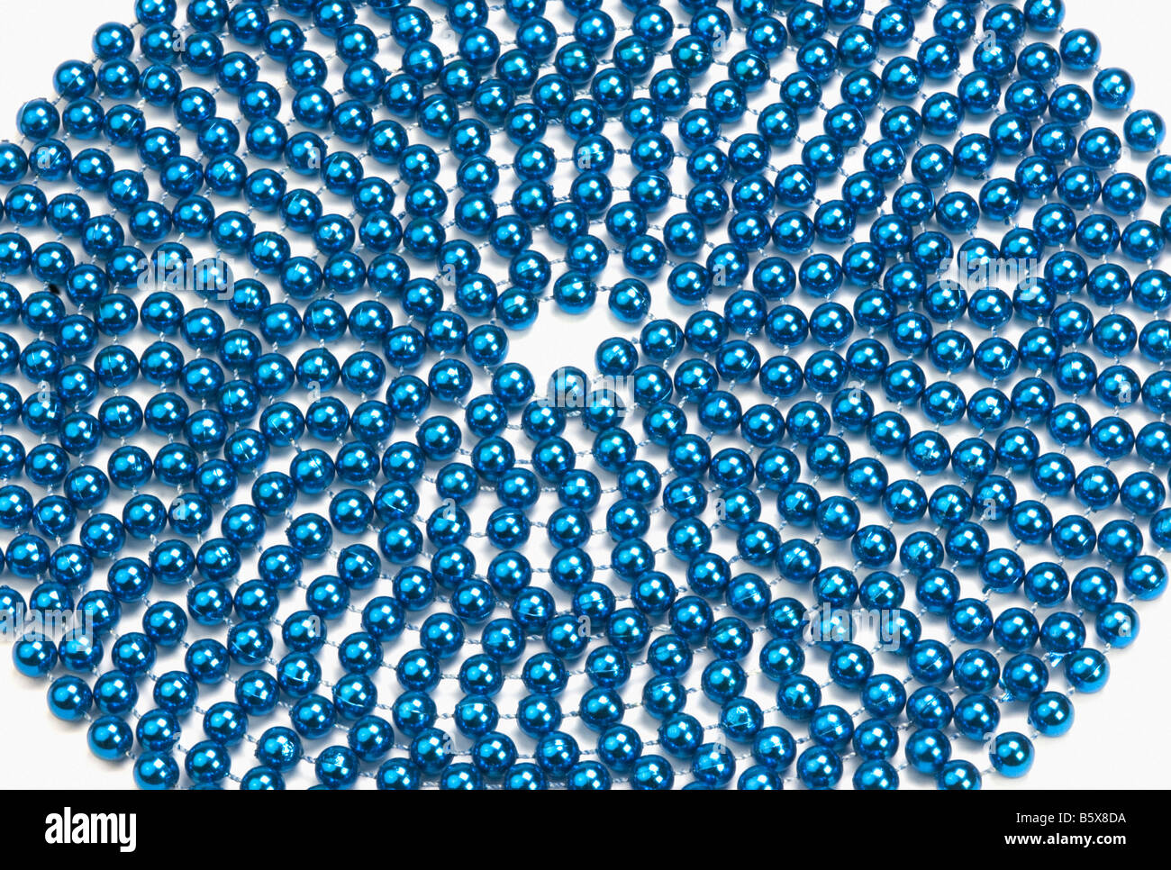Circular pattern of string of blue beads Stock Photo - Alamy
