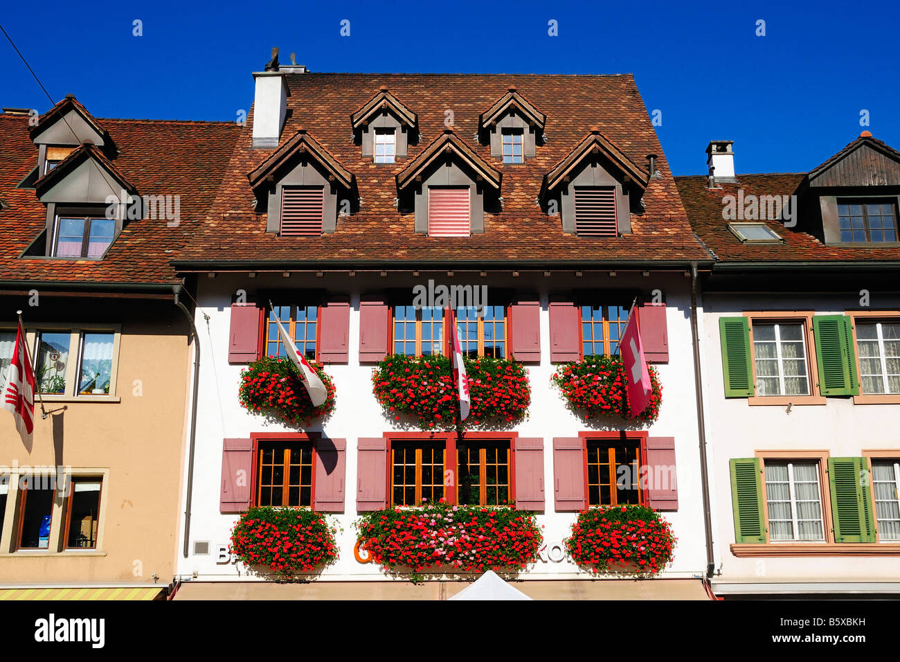 Flags are displayed on the houses in a typical Swiss Town in north ...
