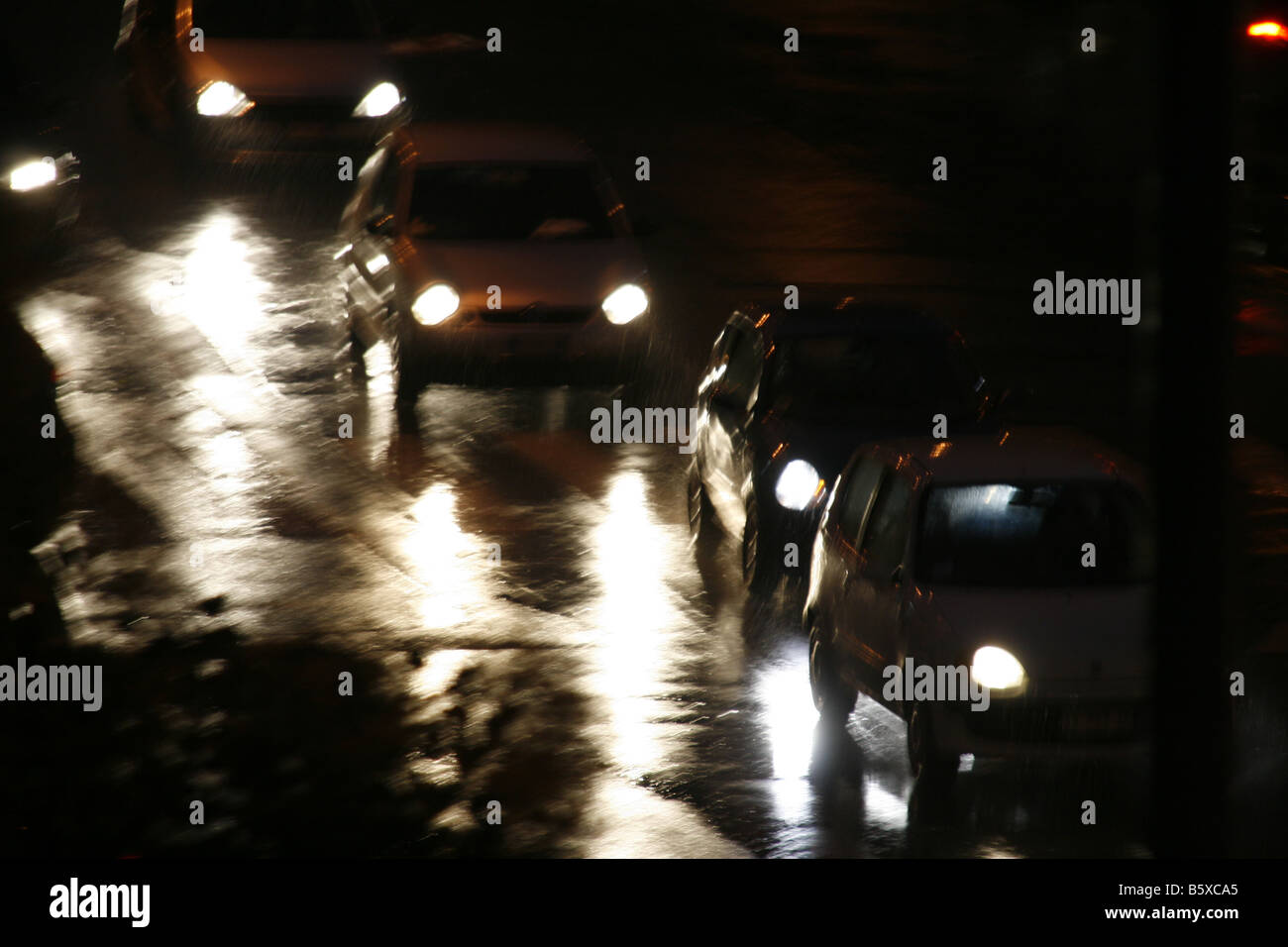 fast car driving in heavy rain at night in town Stock Photo - Alamy