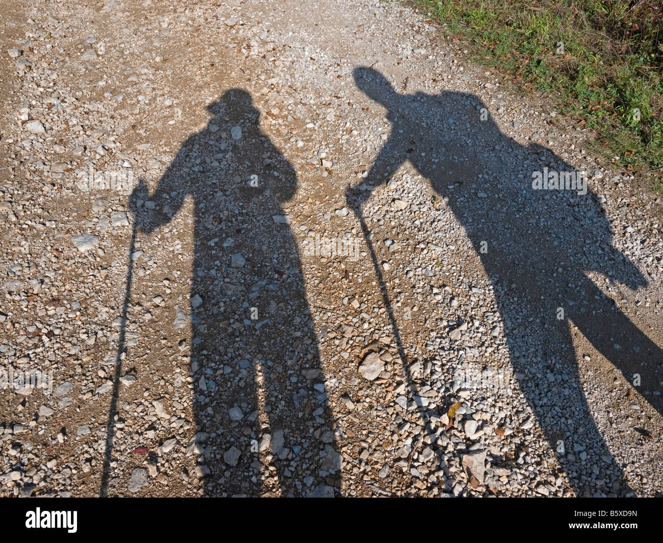 shadow of two persons by hiking walking on a treck Stock Photo - Alamy