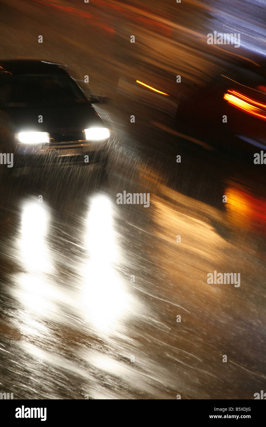 fast car driving in heavy rain at night in town Stock Photo - Alamy