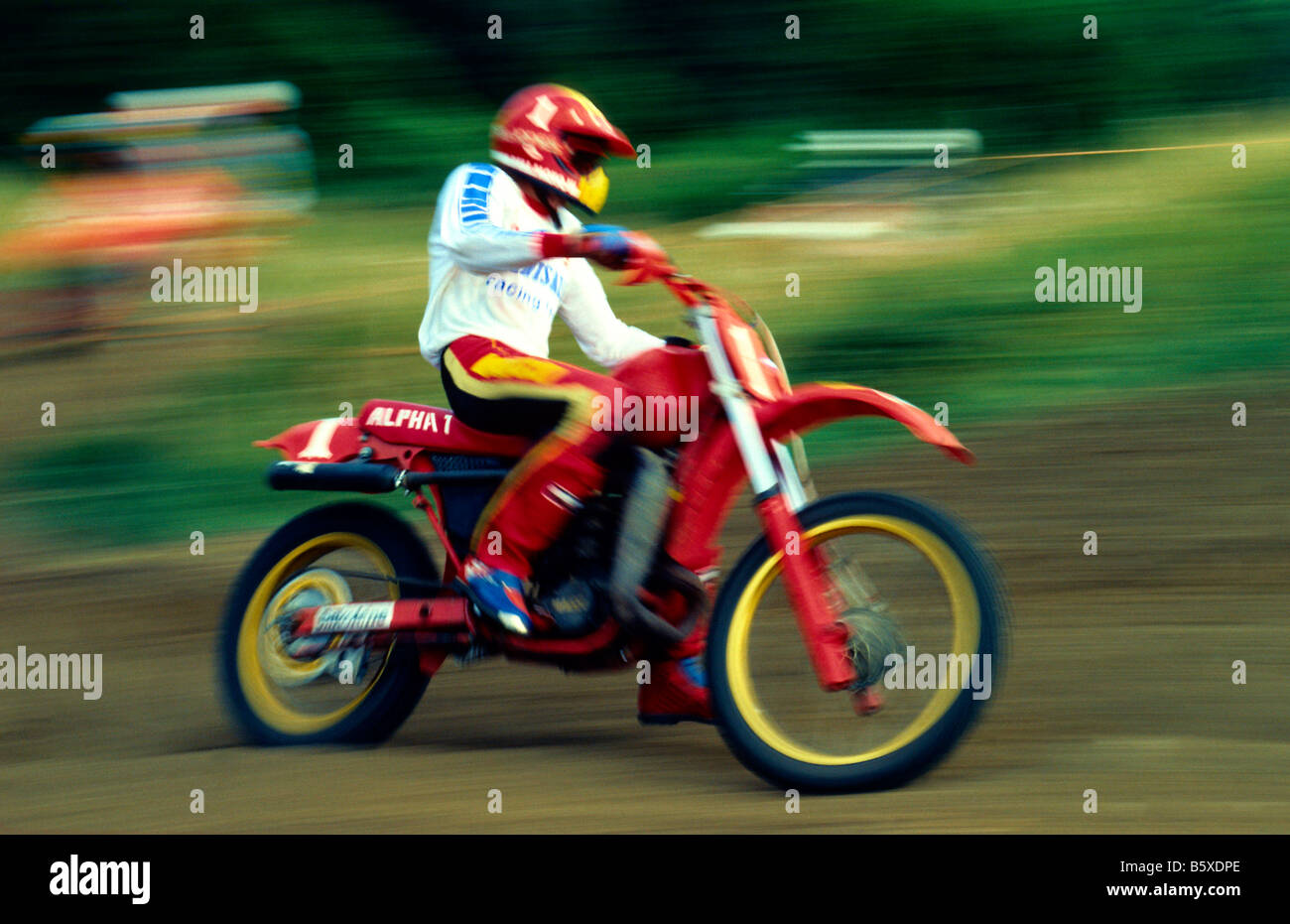 Speeding scrambler / motocross bike rider Stock Photo - Alamy