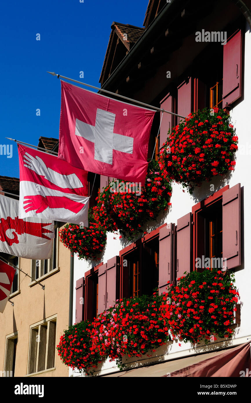 Flags are displayed on the houses in a typical Swiss Town in north ...