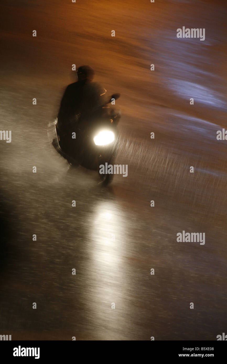 fast motorbike rider heavy rain at night in town Stock Photo - Alamy