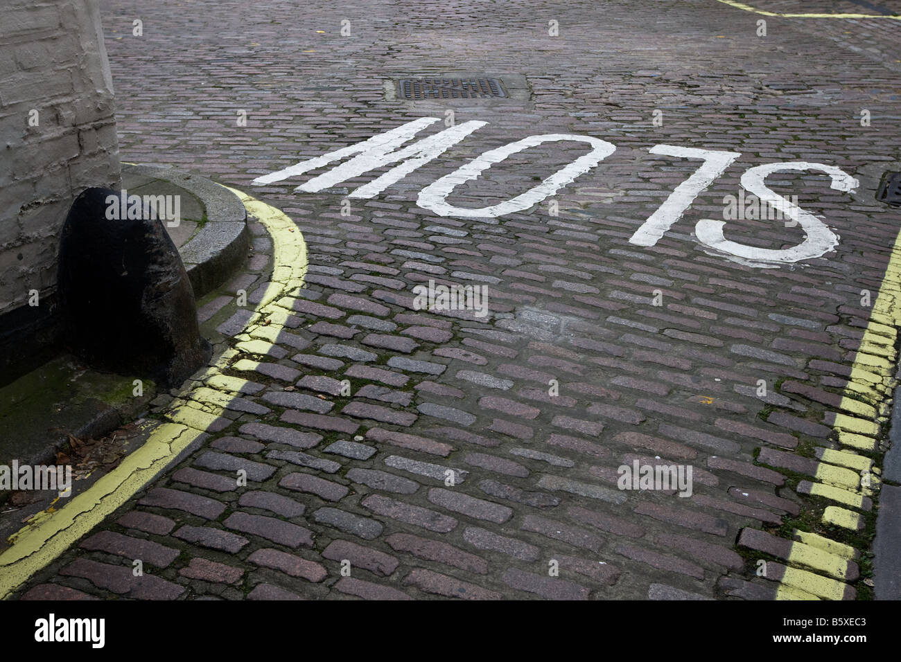 Slow road markings with yellow lines Stock Photo - Alamy