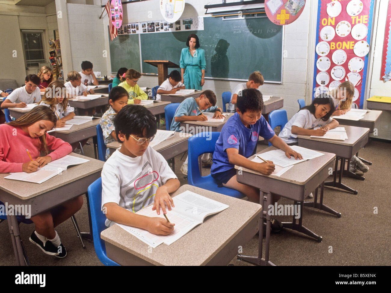 Junior high school class takes exam as teacher watches. test Stock ...