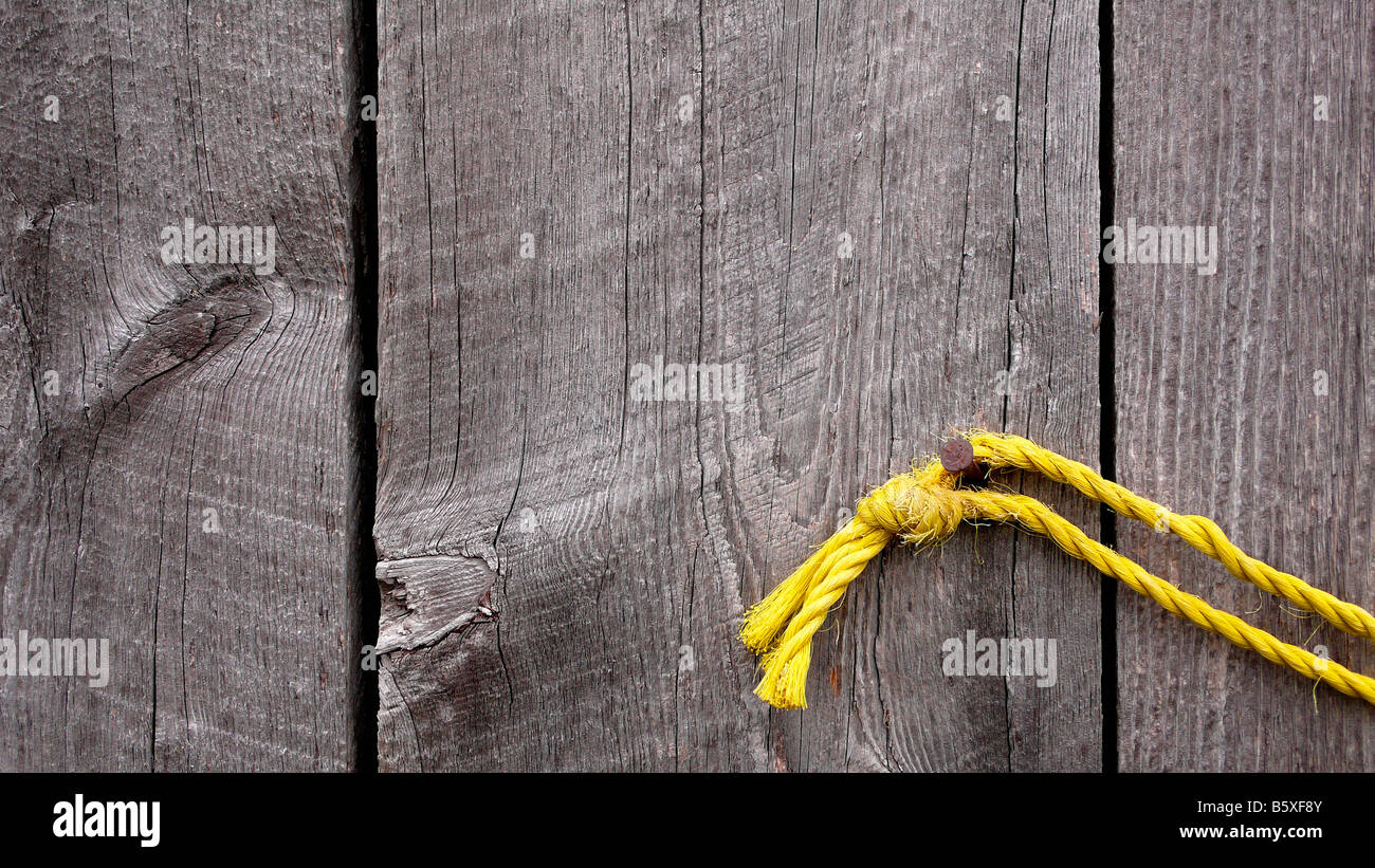 Yellow rope on old weathered wood texture Stock Photo - Alamy
