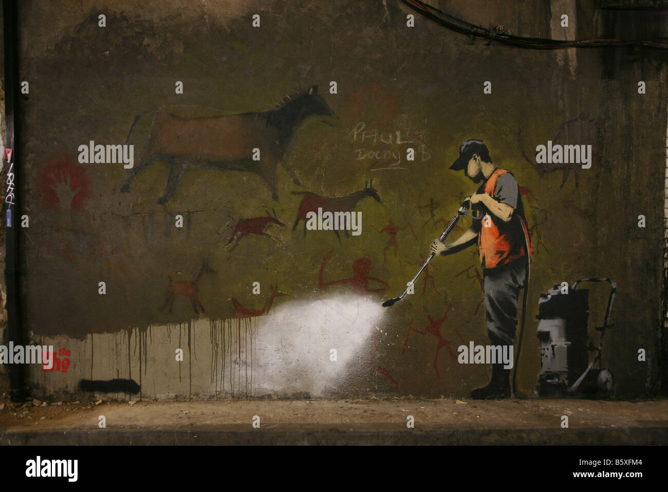 cleaning removing Banksy graffiti artist art remove all Stock Photo - Alamy