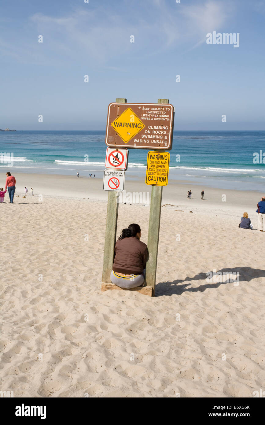 overweight woman stuck in sign on beach Stock Photo - Alamy