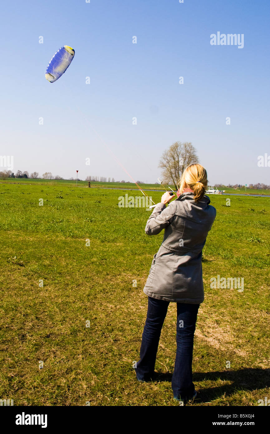 Girl flying a kite in an open landscape Stock Photo - Alamy