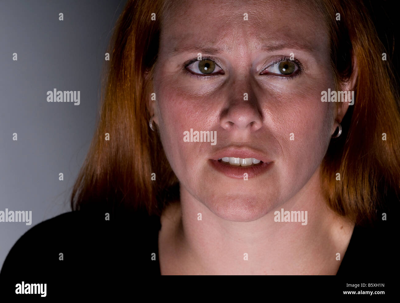 Woman looking frightened and dramatic Stock Photo - Alamy