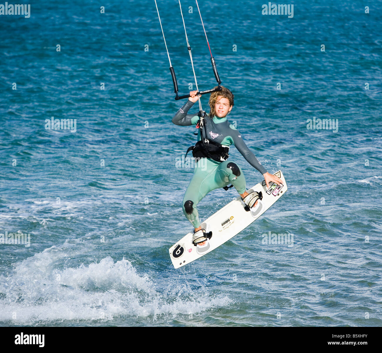 Young woman jumping on kiteboard Stock Photo - Alamy