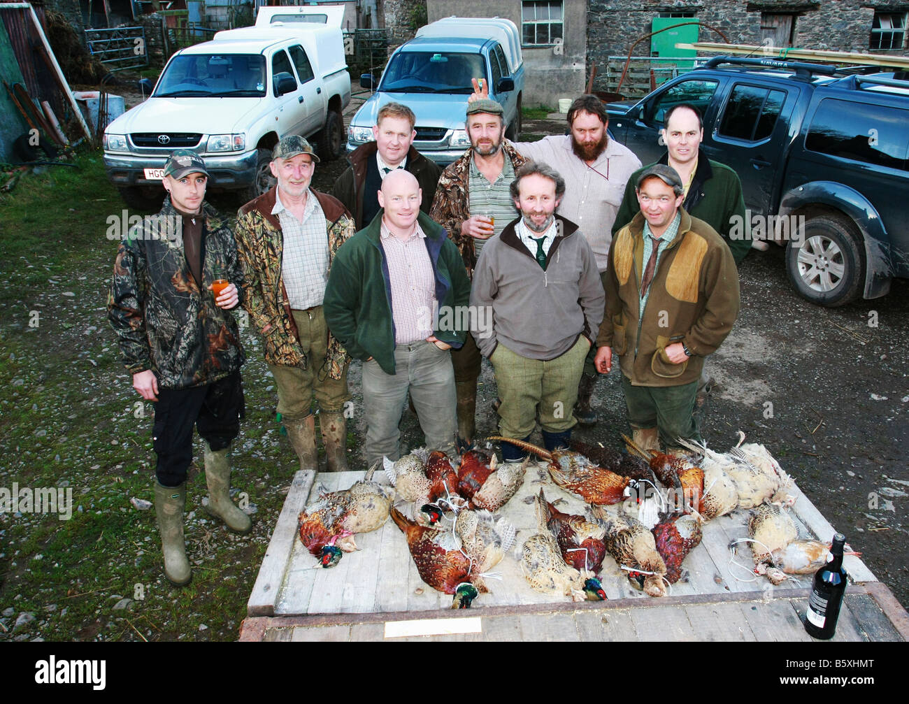 Members of a driven bird shoot stand in front of a collection of dead ...