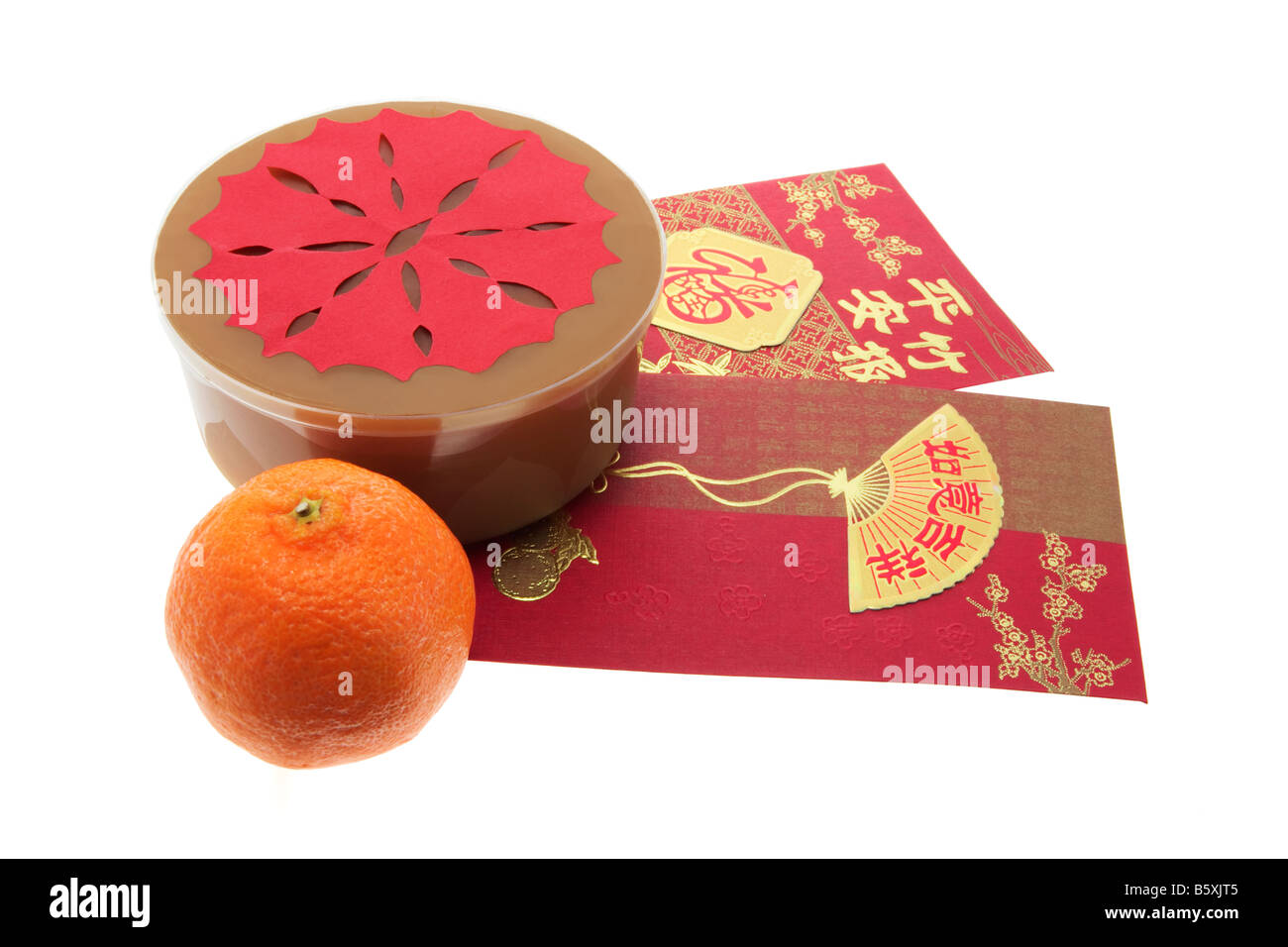 Chinese New Year Cake and Red Packets Stock Photo - Alamy