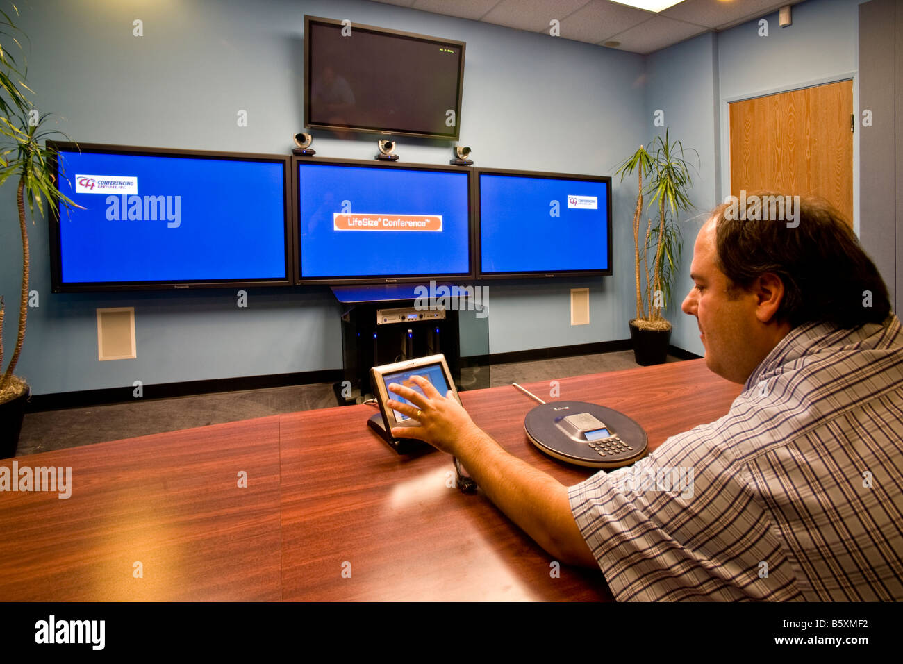 Dialing a touch screen telephone a California businessman prepares to ...