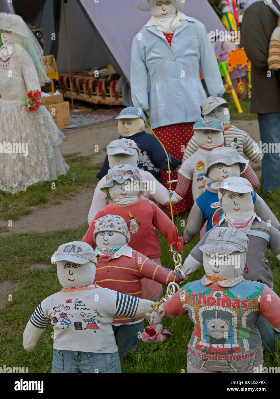 lots of dressed dolls as children in primary school in garden in ...