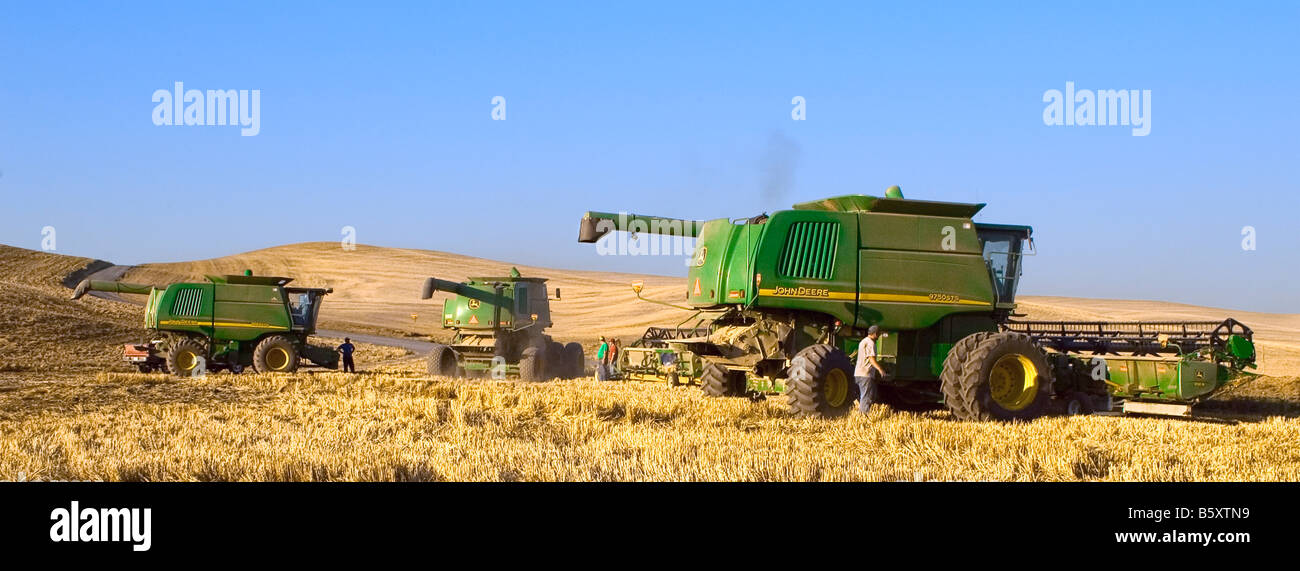 Members of the harvest crew prepare combines for movement to another ...