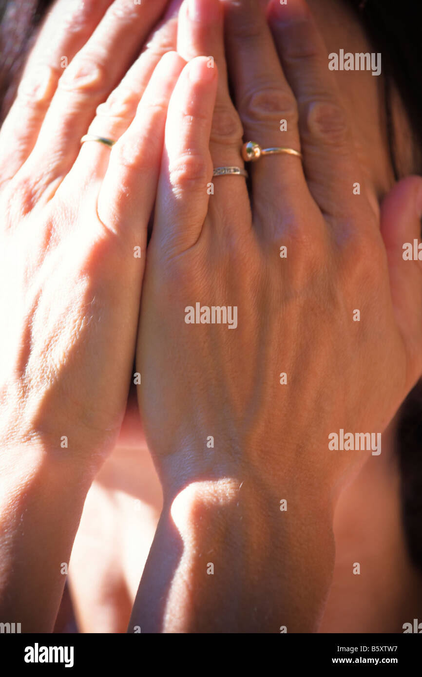 woman hiding her face with her hands Stock Photo - Alamy