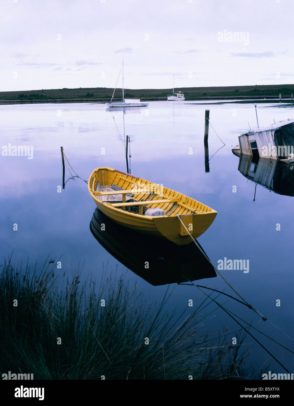 Yellow wooden dinghy Stock Photo - Alamy