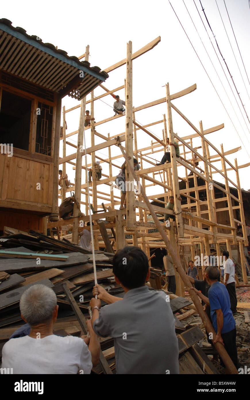 Ethnic Miao (Hmong) villagers get together to construct a home in the ...