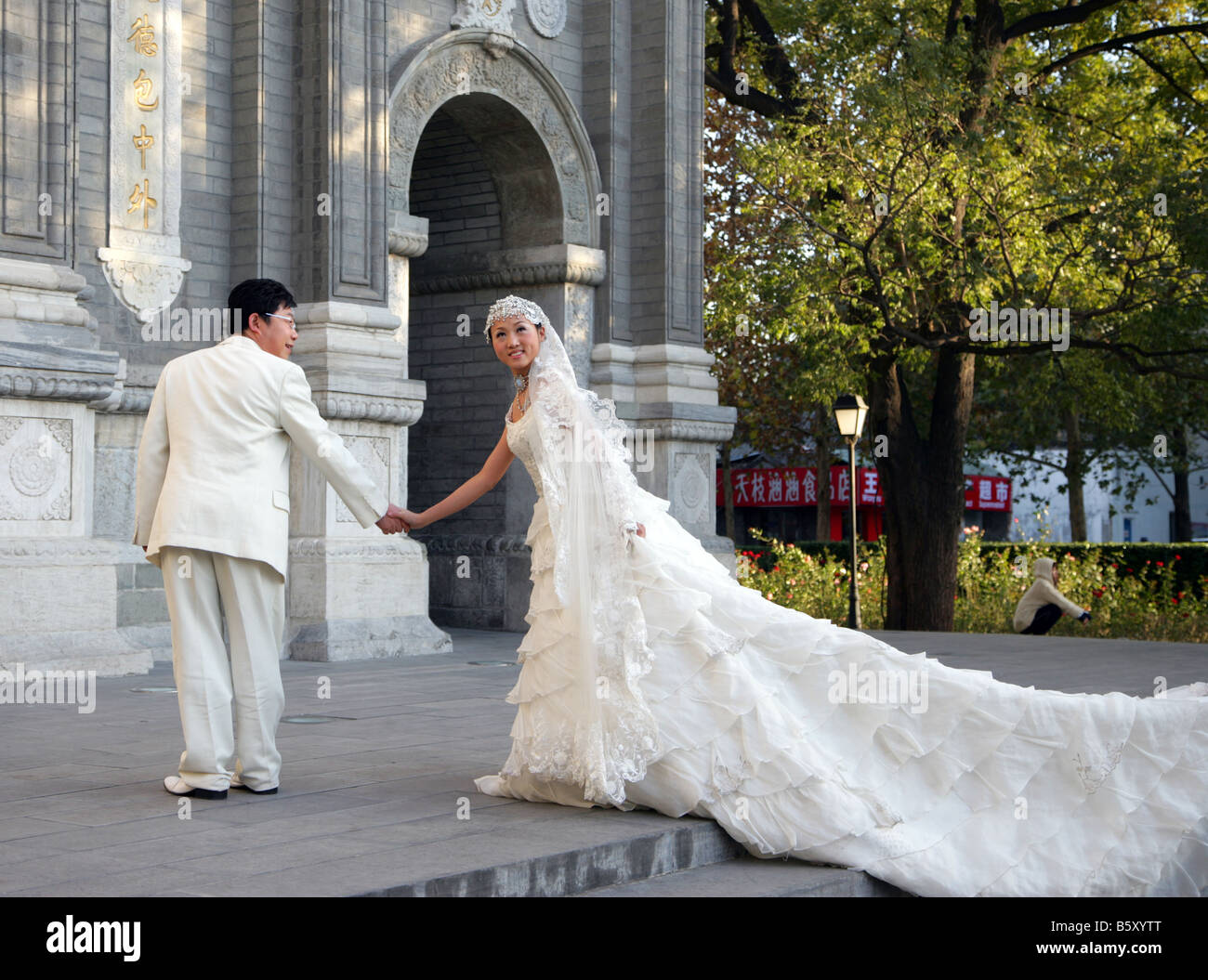 Chinese bride and groom posing for wedding photographs Church of St ...