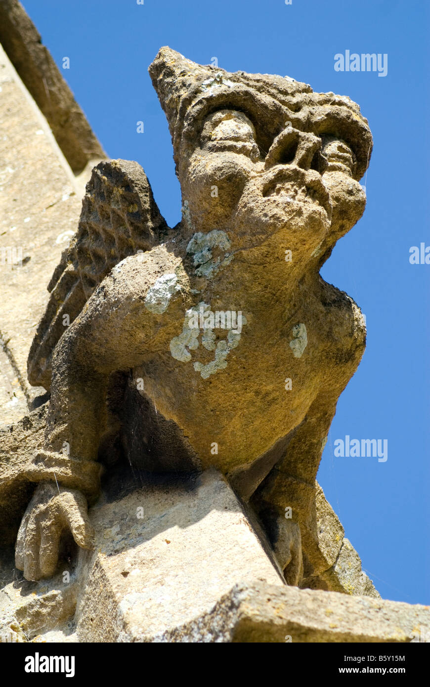 Gargoyle above a medieval parish church, Winchcombe, Gloucestershire ...