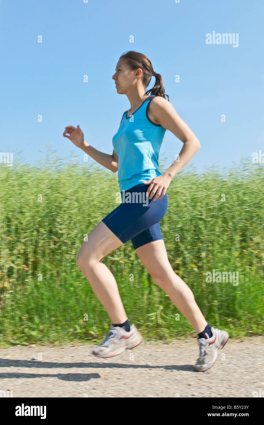 Young woman jogging Stock Photo - Alamy