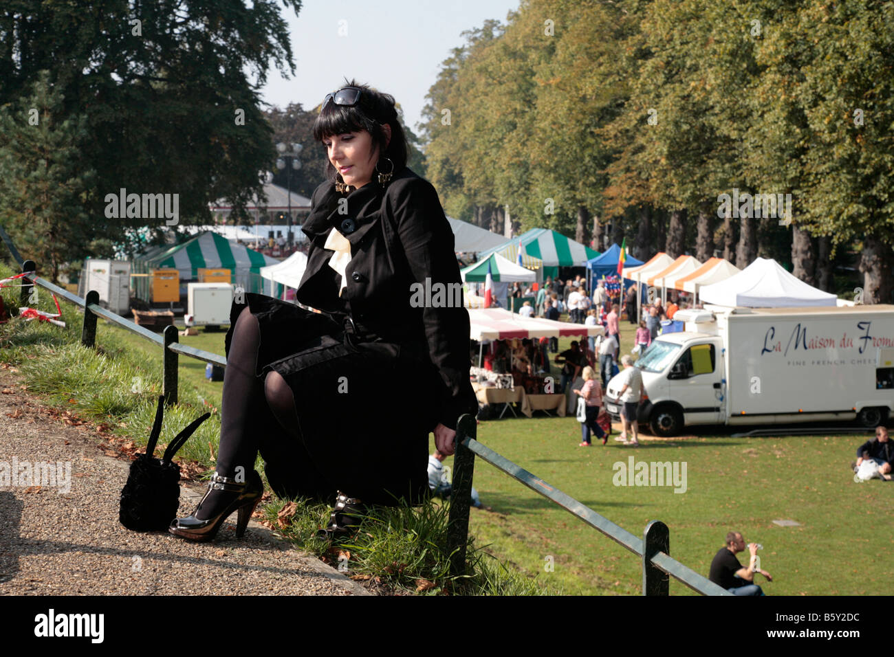 Girl sitting on railings hi-res stock photography and images - Alamy