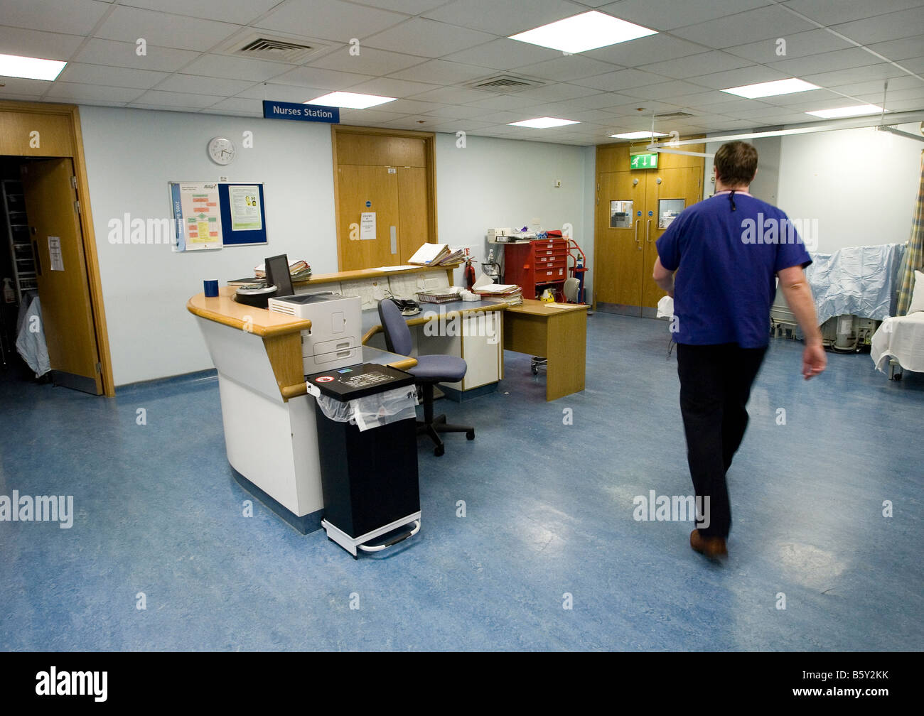 A doctor walks through a reception area at an NHS hospital in UK Stock ...
