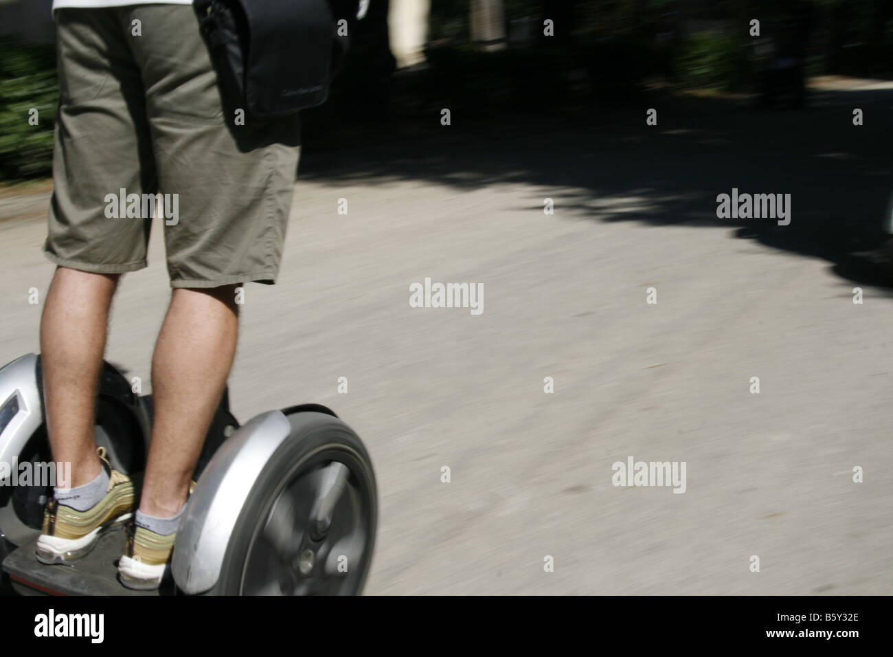 person tourist riding segway personal transporter on street in town ...