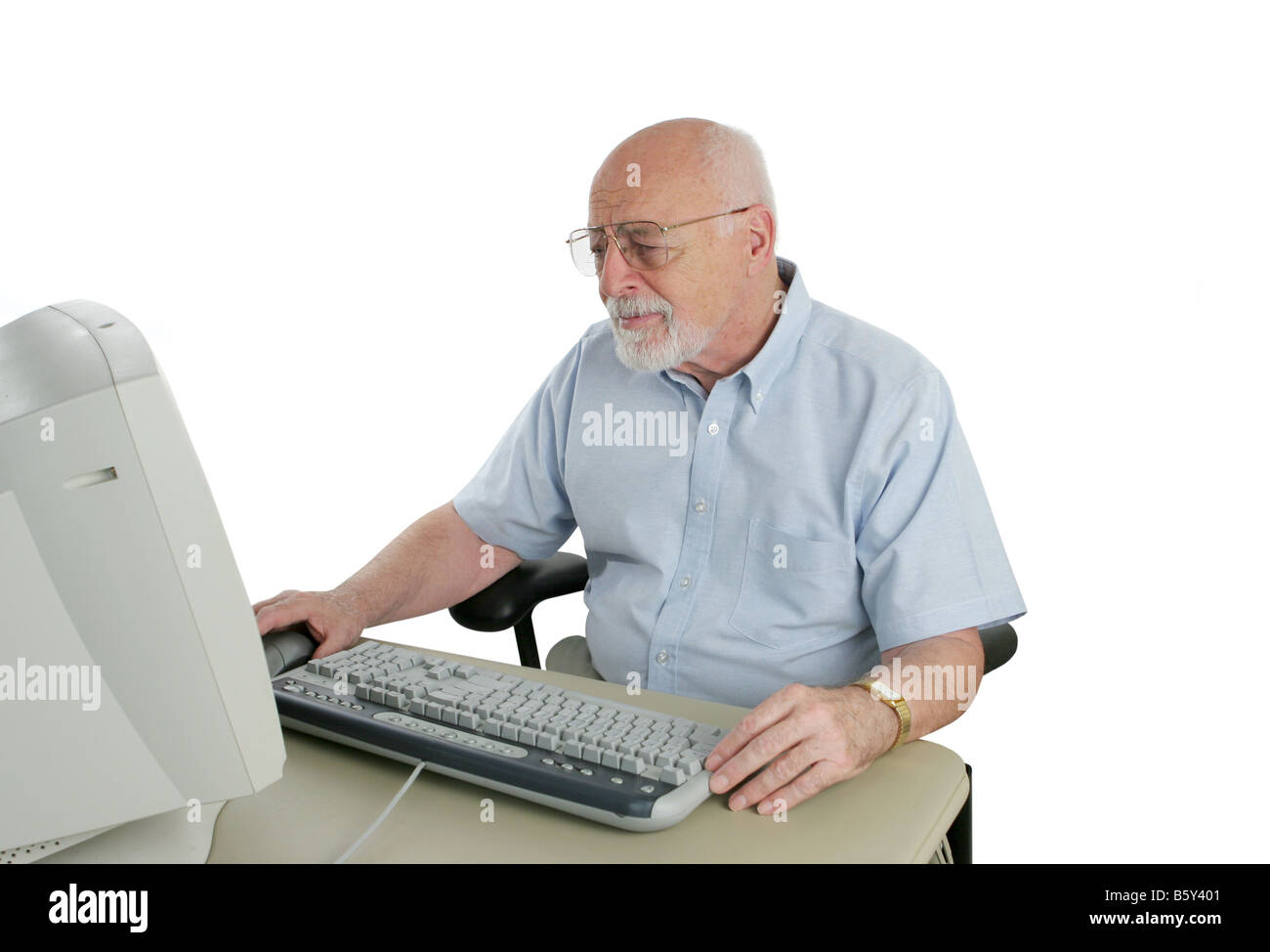 A a senior man learning the computer with an expression of ...