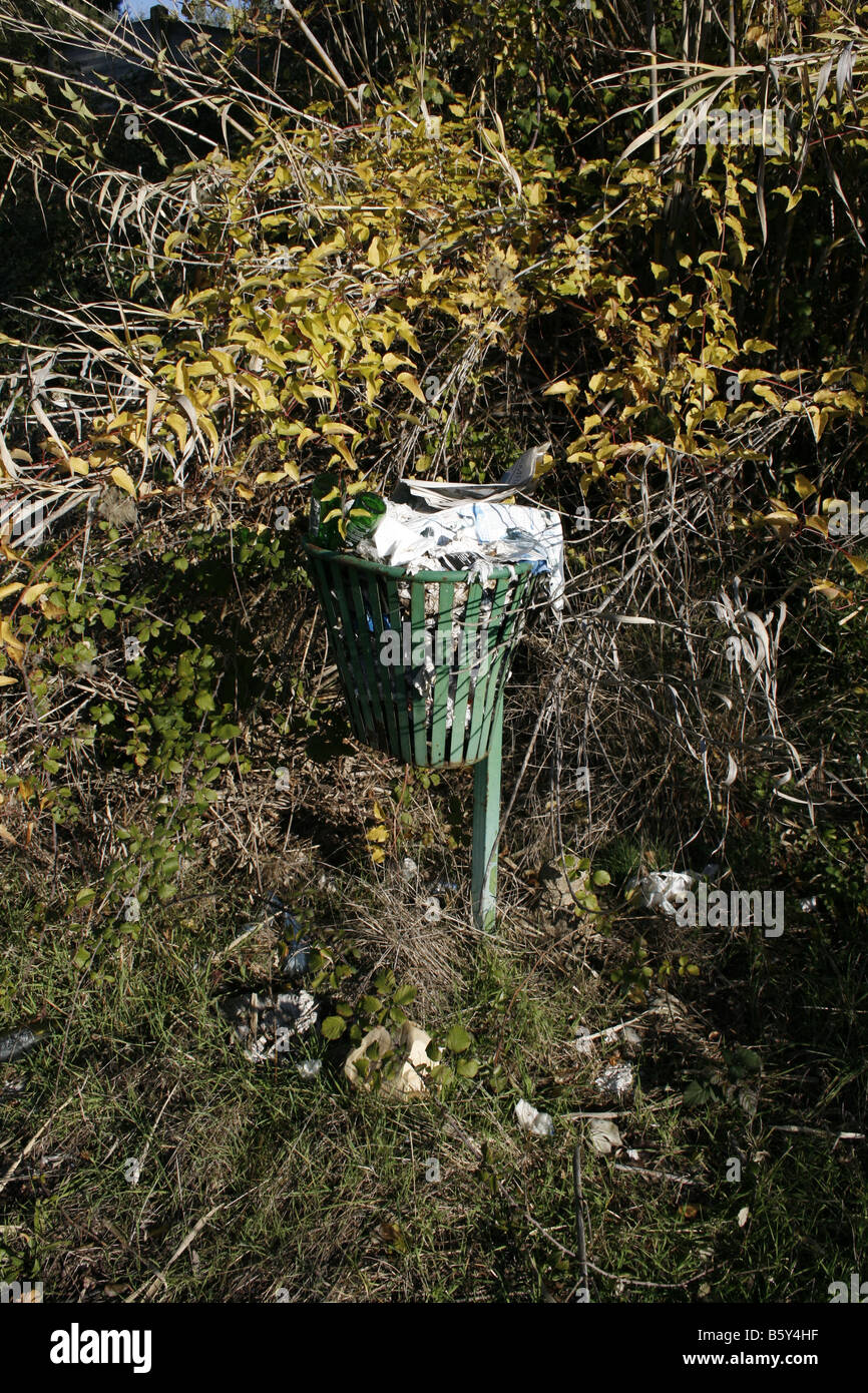 full litter rubbish bin in park in countryside Stock Photo - Alamy