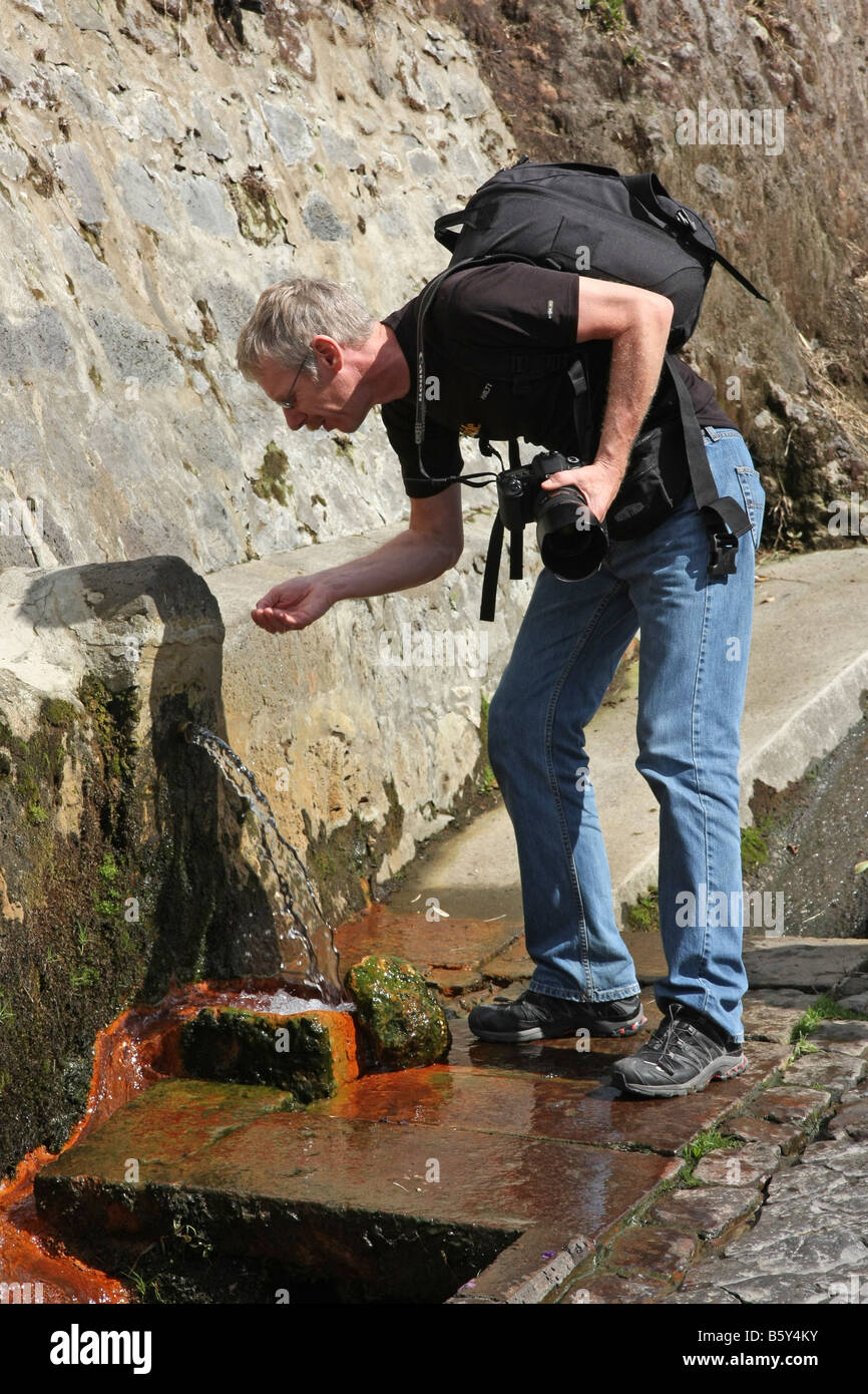 Tourist drinking from a spring with naturally carbonated water in ...