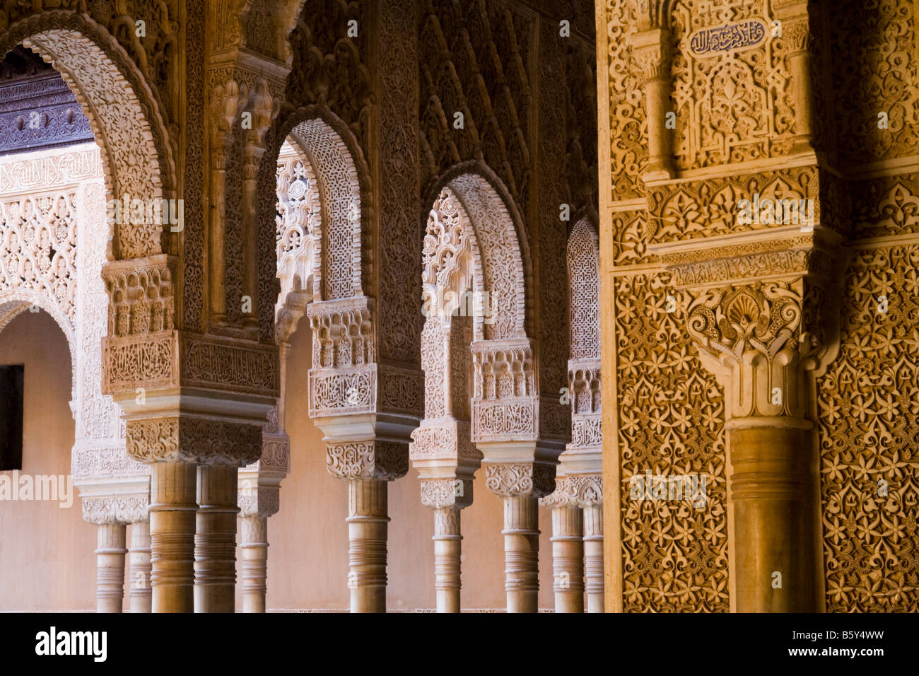 Carved stucco arabesques adorn the arches and columns of the Court of ...