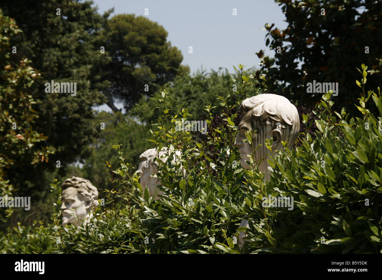 statues amongst trees foliage in villa borghese rome Stock Photo - Alamy